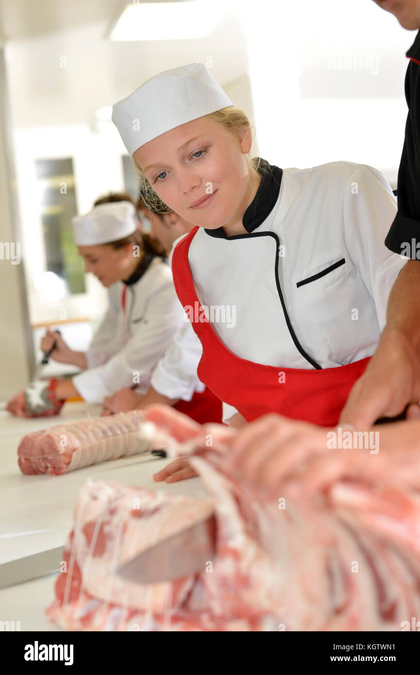 Professional butcher teaching student with meat cutting Stock Photo - Alamy