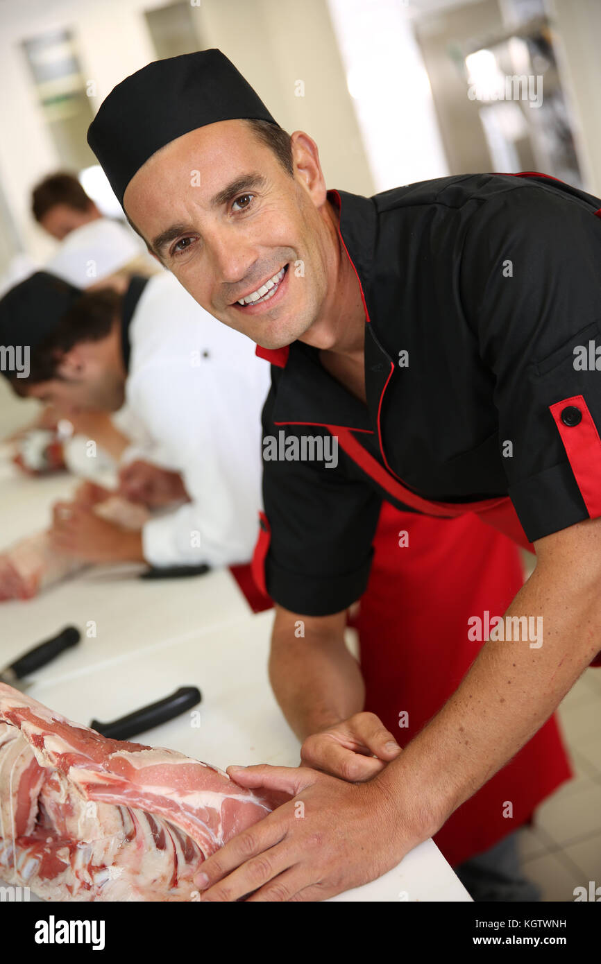 Portrait of smiling butcher standing in kitchen Stock Photo - Alamy