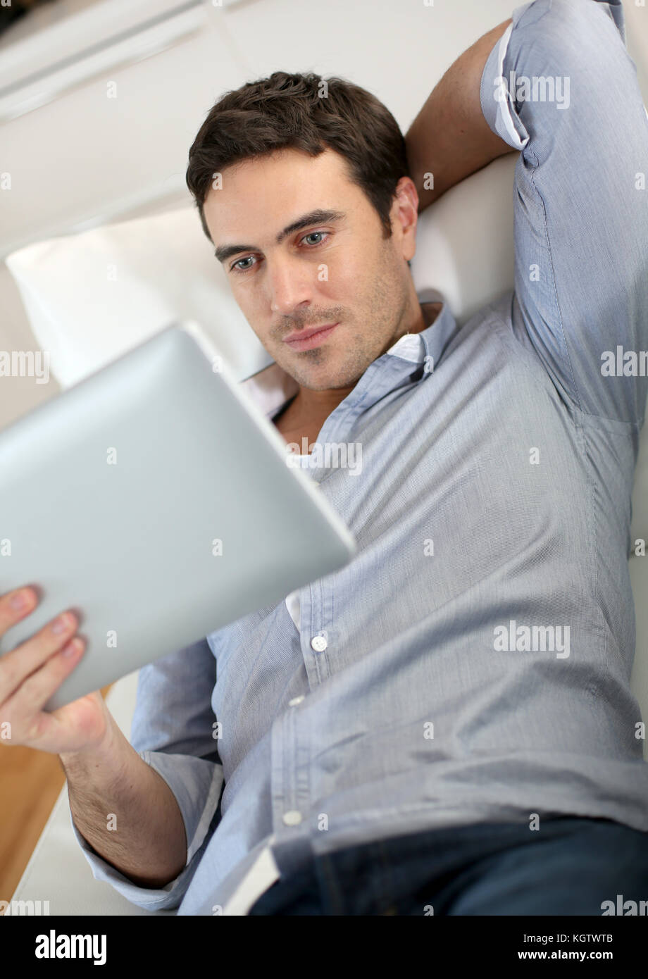 Man websurfing on internet with digital tablet Stock Photo - Alamy