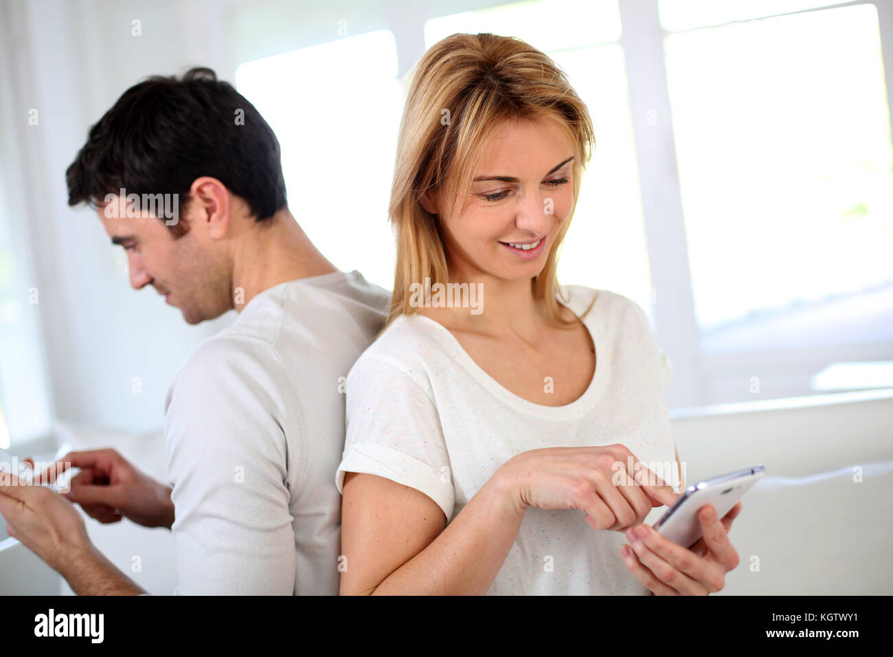 Couple sending message smartphone hi-res stock photography and images ...