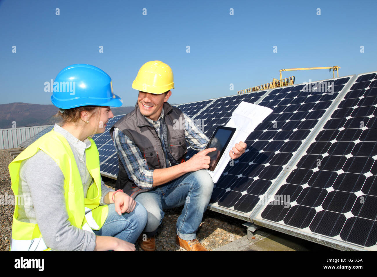 Man showing solar panels technology to student girl Stock Photo - Alamy