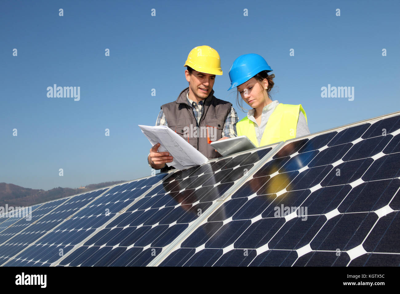 Man showing solar panels technology to student girl Stock Photo - Alamy