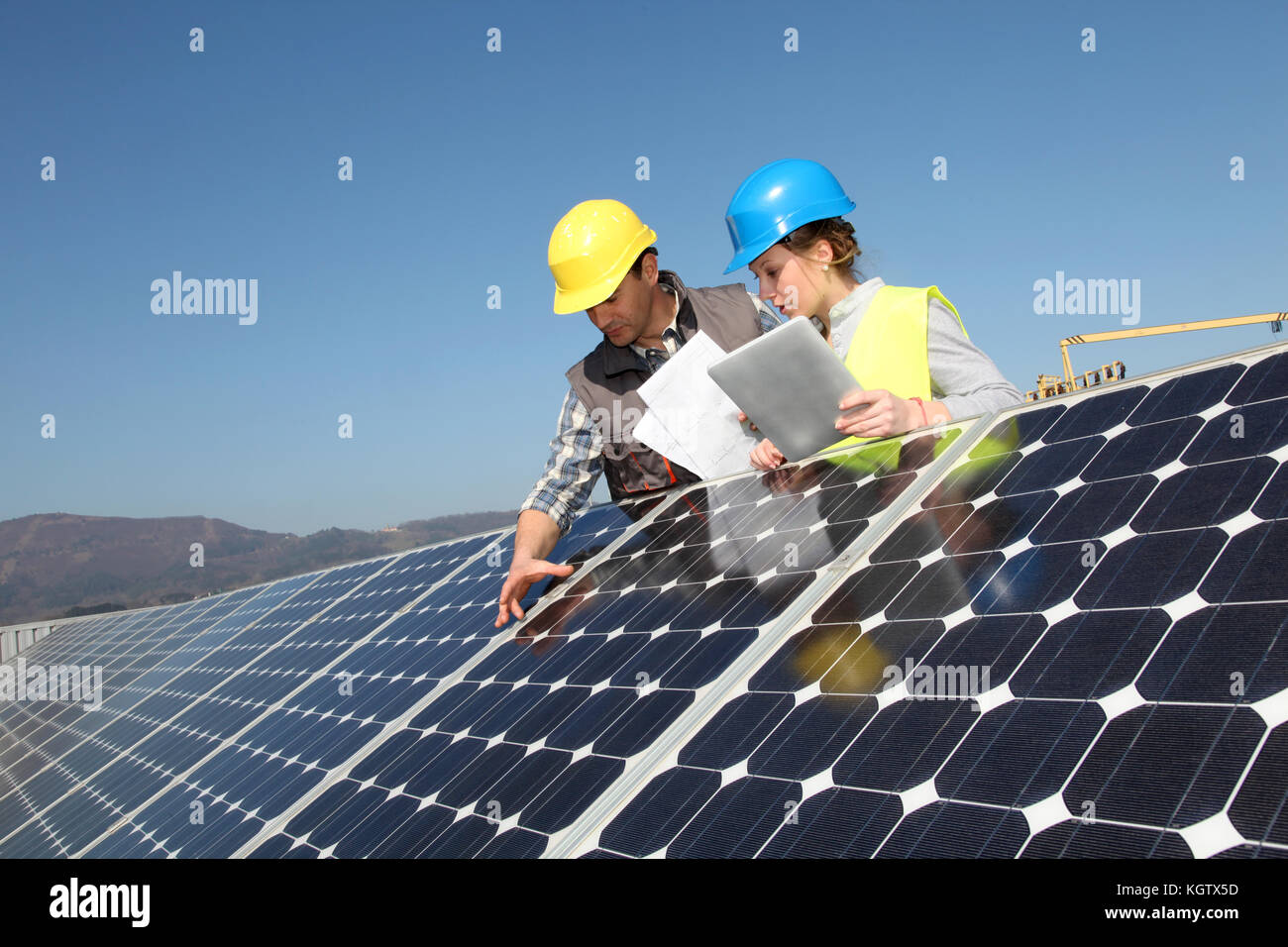 Man showing solar panels technology to student girl Stock Photo - Alamy