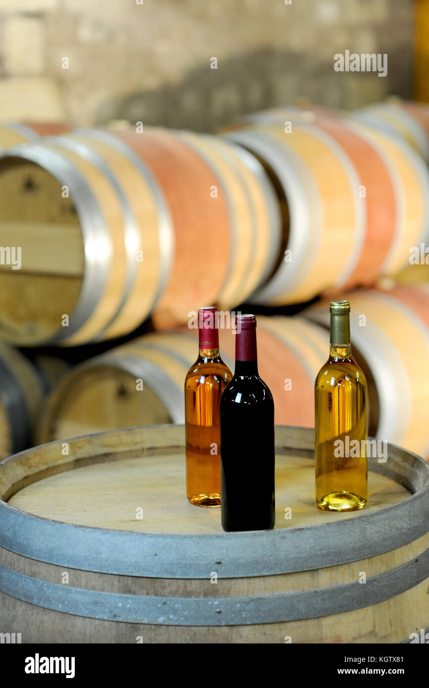 Closeup of bottles of wine set on barrel Stock Photo - Alamy