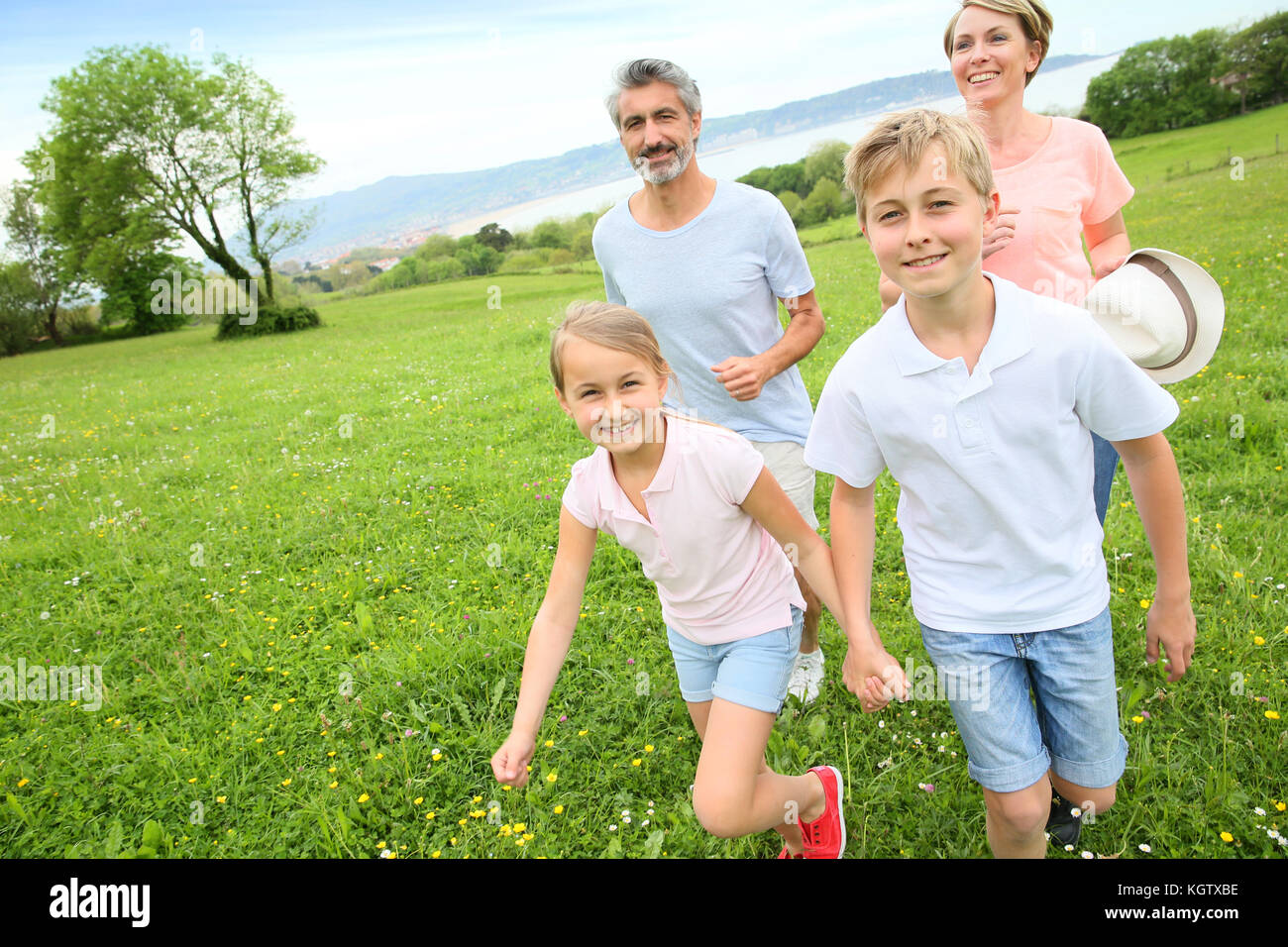 Four children running hi-res stock photography and images - Alamy