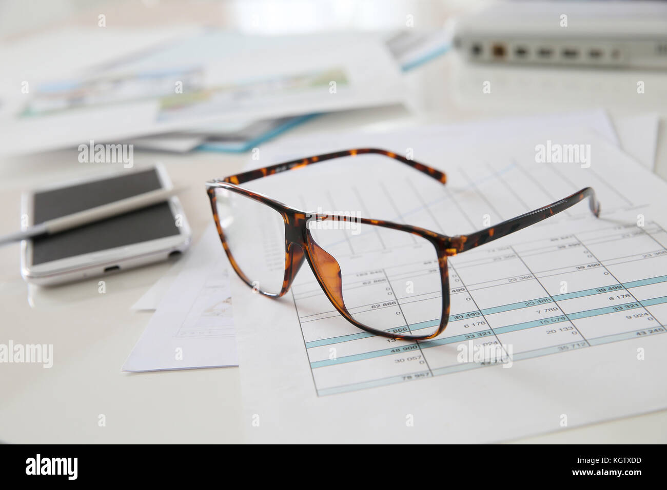Eyeglasses set on business meeting table Stock Photo - Alamy
