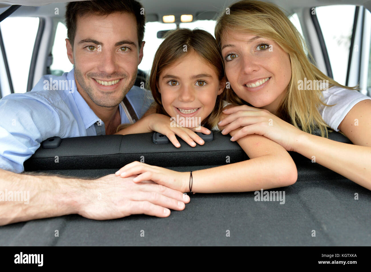 Cheerful family of three ready for vacation Stock Photo - Alamy