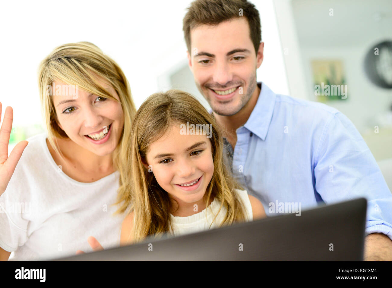 Family having fun chating on internet with laptop Stock Photo - Alamy