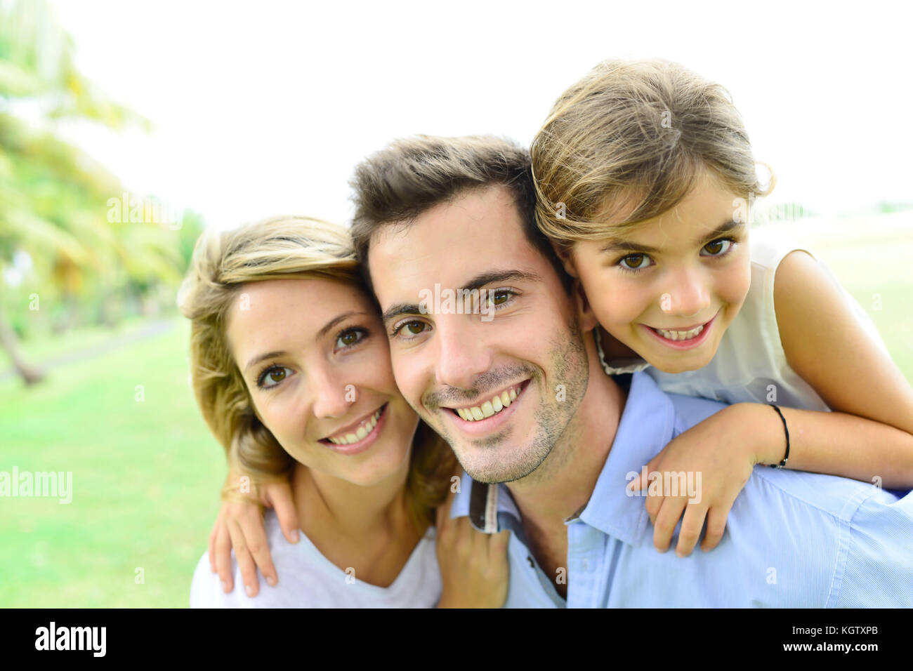 Portrait of happy family standing in park Stock Photo - Alamy