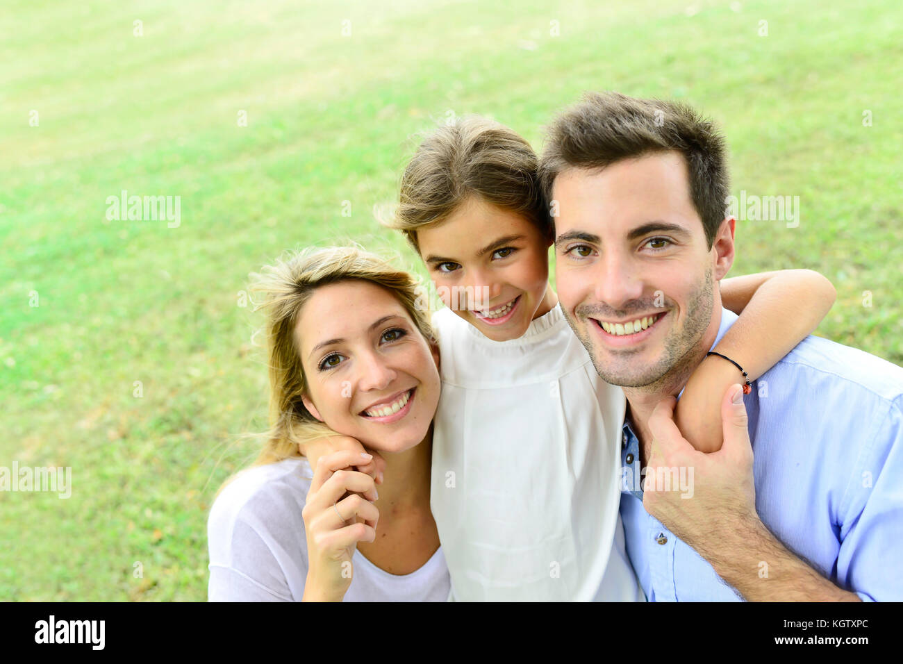 Portrait of happy family standing in park Stock Photo - Alamy