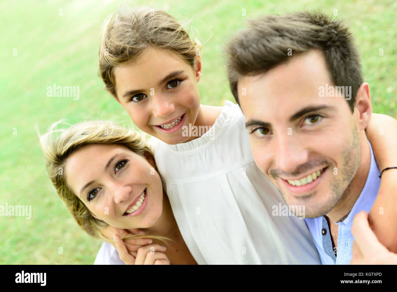 Portrait of happy family standing in park Stock Photo - Alamy