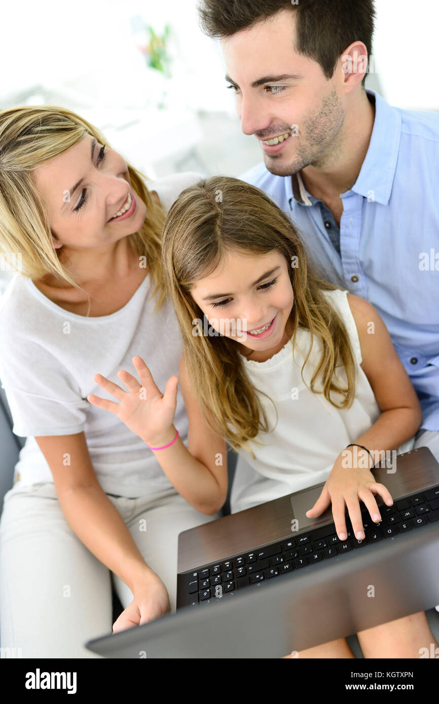 Family having fun chating on internet with laptop Stock Photo - Alamy