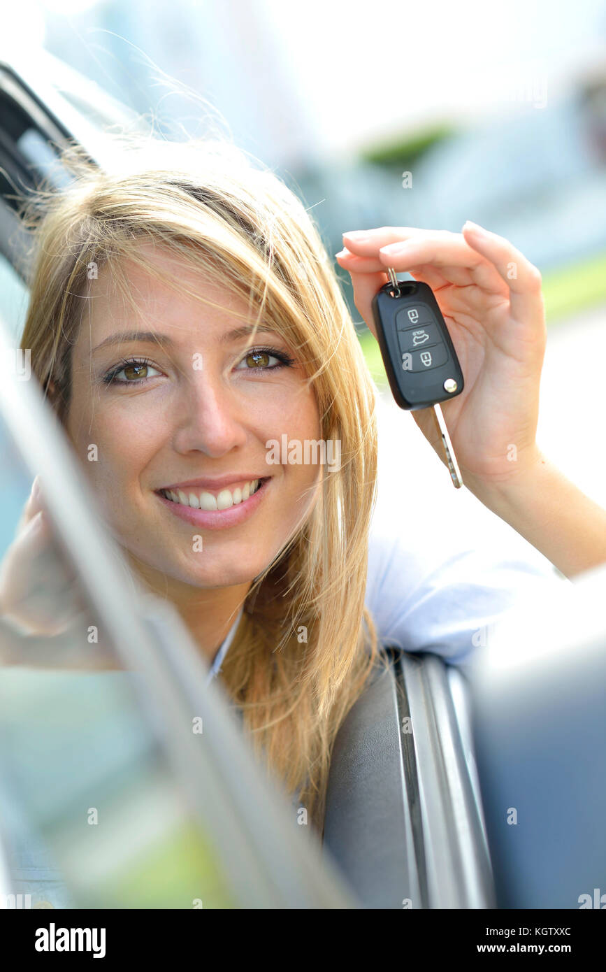 Cheerful young woman showing car key Stock Photo - Alamy