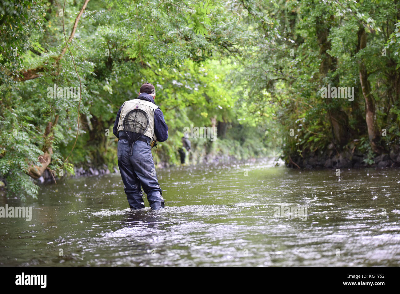 Back view of fly-fisherman fishing in river Stock Photo - Alamy