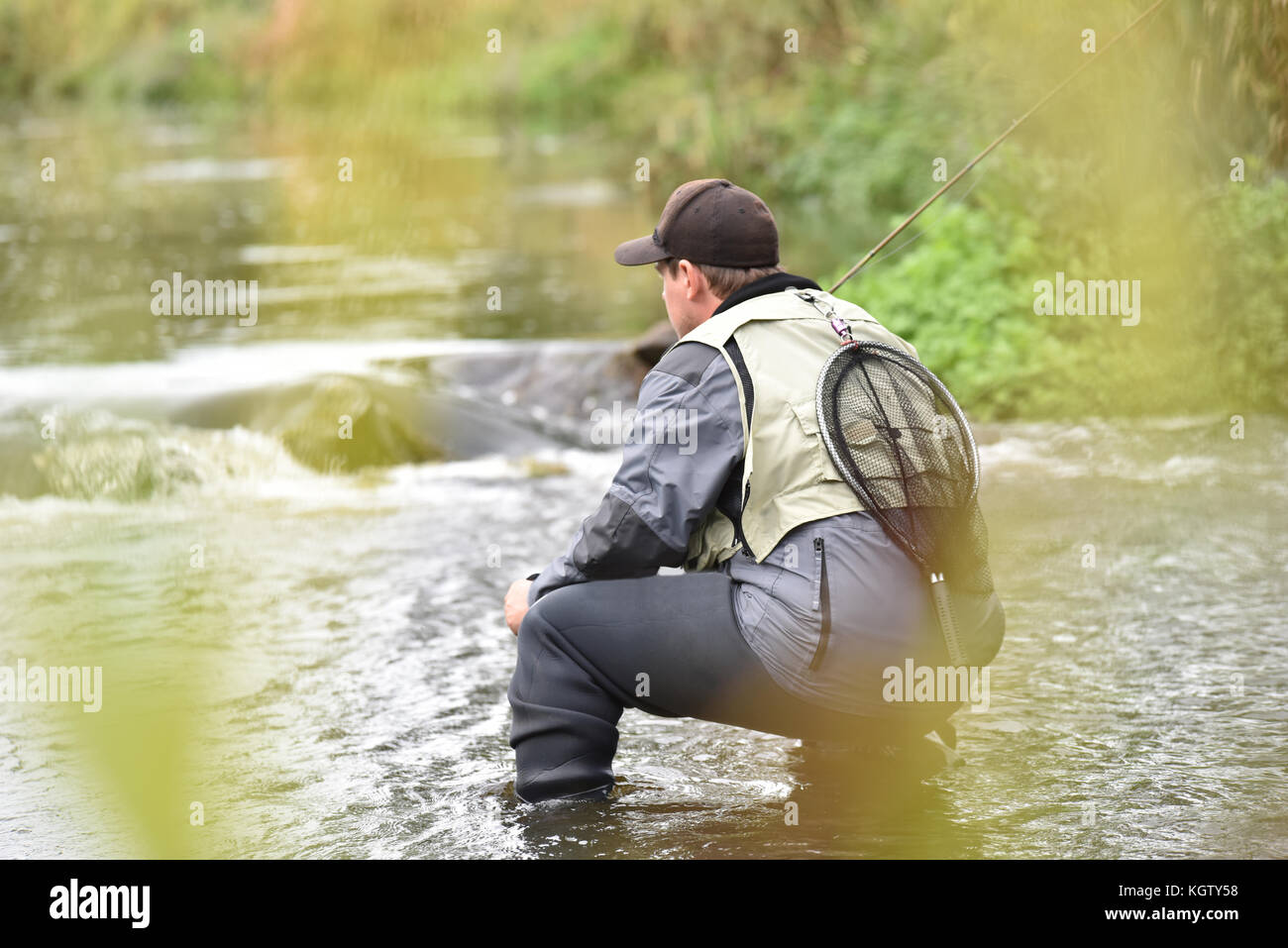 Back view of fly-fisherman fishing in river Stock Photo - Alamy