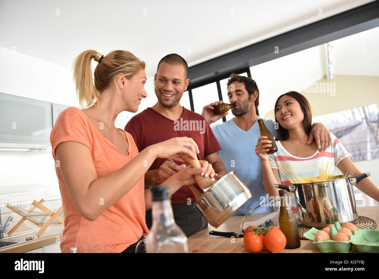 Friends having fun cooking together Stock Photo - Alamy
