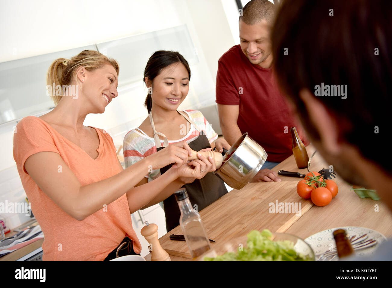 Friends having fun cooking together Stock Photo - Alamy