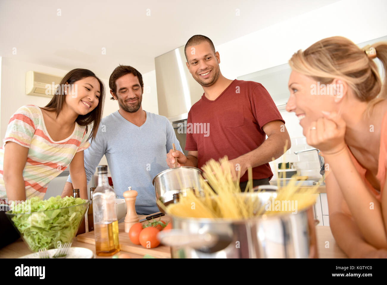 Friends having fun cooking together Stock Photo - Alamy