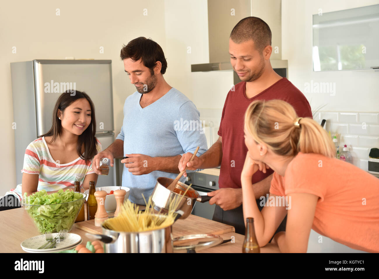 Friends having fun cooking together Stock Photo - Alamy