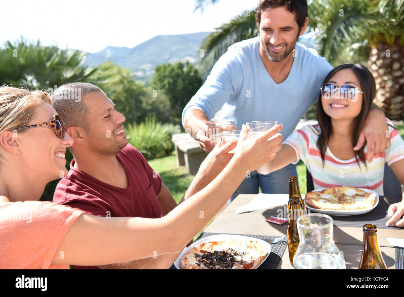 Friends having lunch outside on a sunny day Stock Photo - Alamy