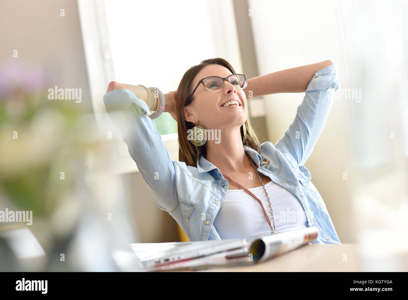 Trendy woman working from home relaxing in chair Stock Photo - Alamy