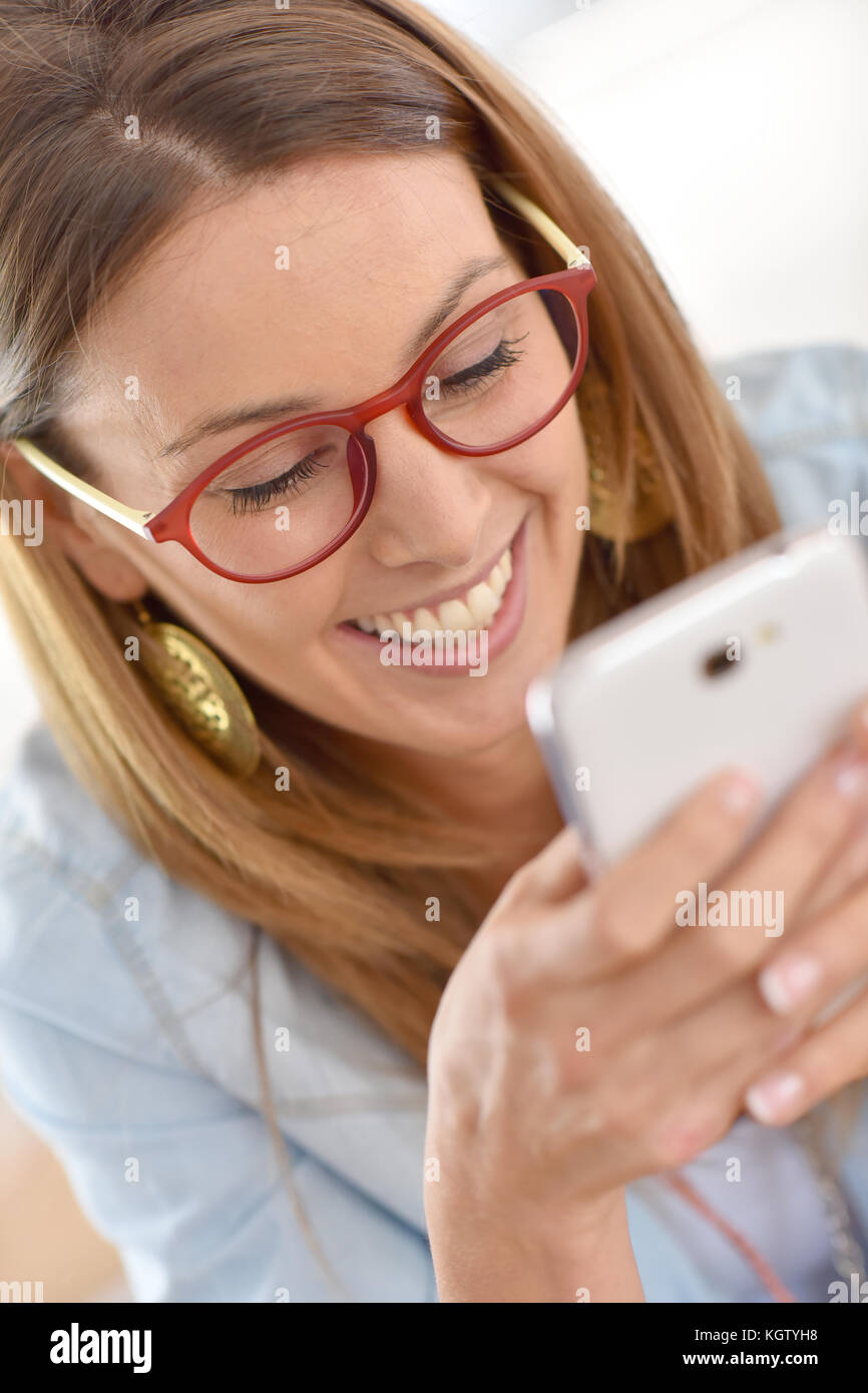 Cheerful girl having fun using smartphone Stock Photo - Alamy