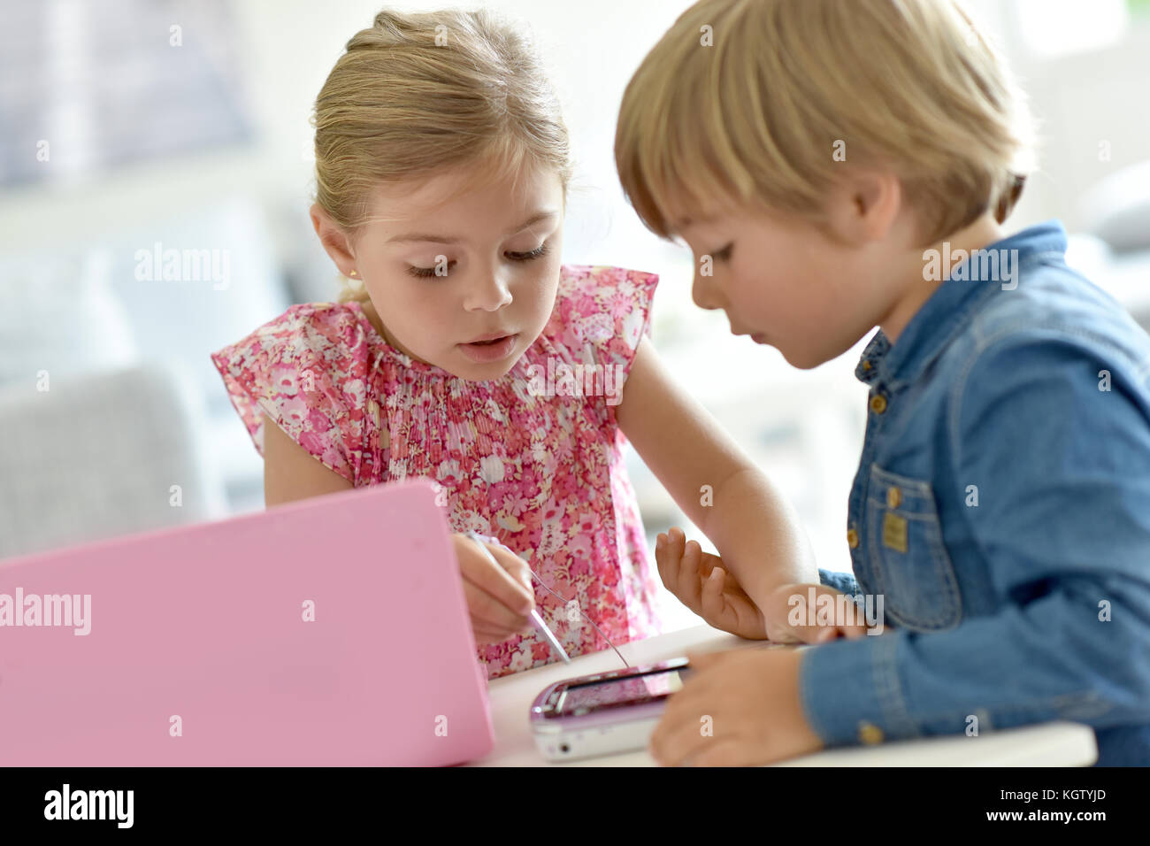 Kids playing with laptop and toy tablet Stock Photo - Alamy