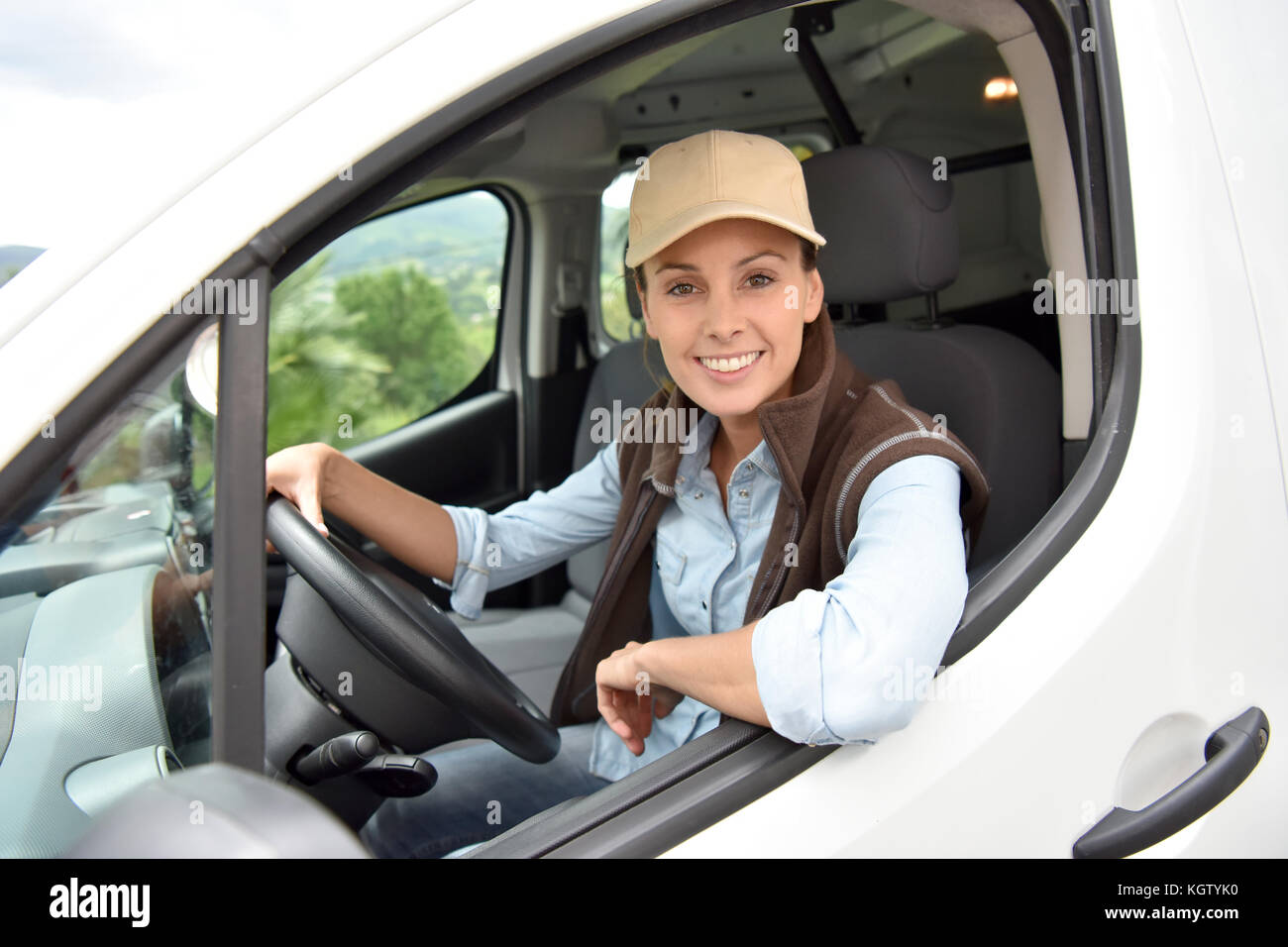 Delivery woman driving van Stock Photo - Alamy