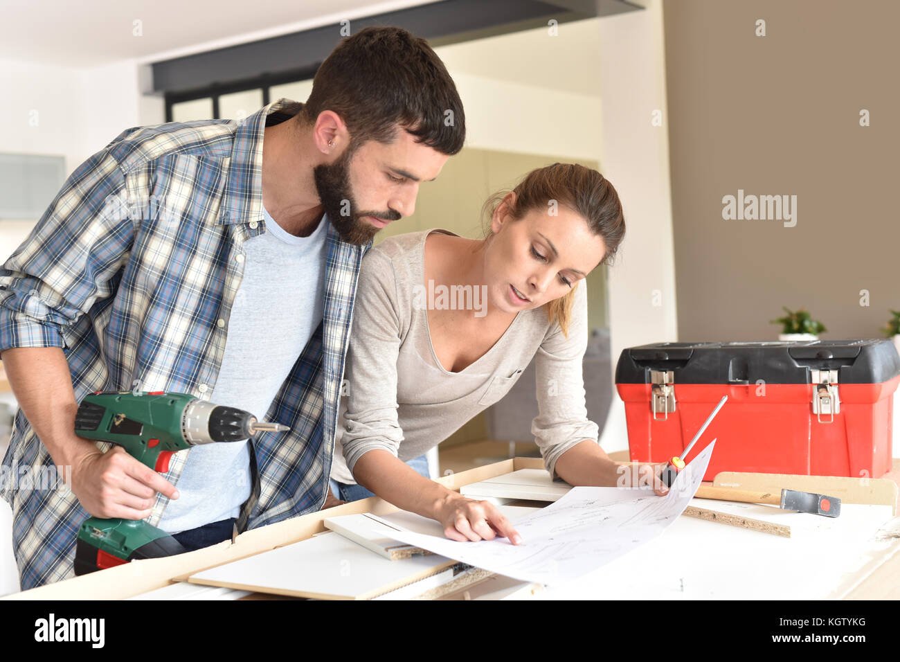 Couple assembling new furniture Stock Photo - Alamy