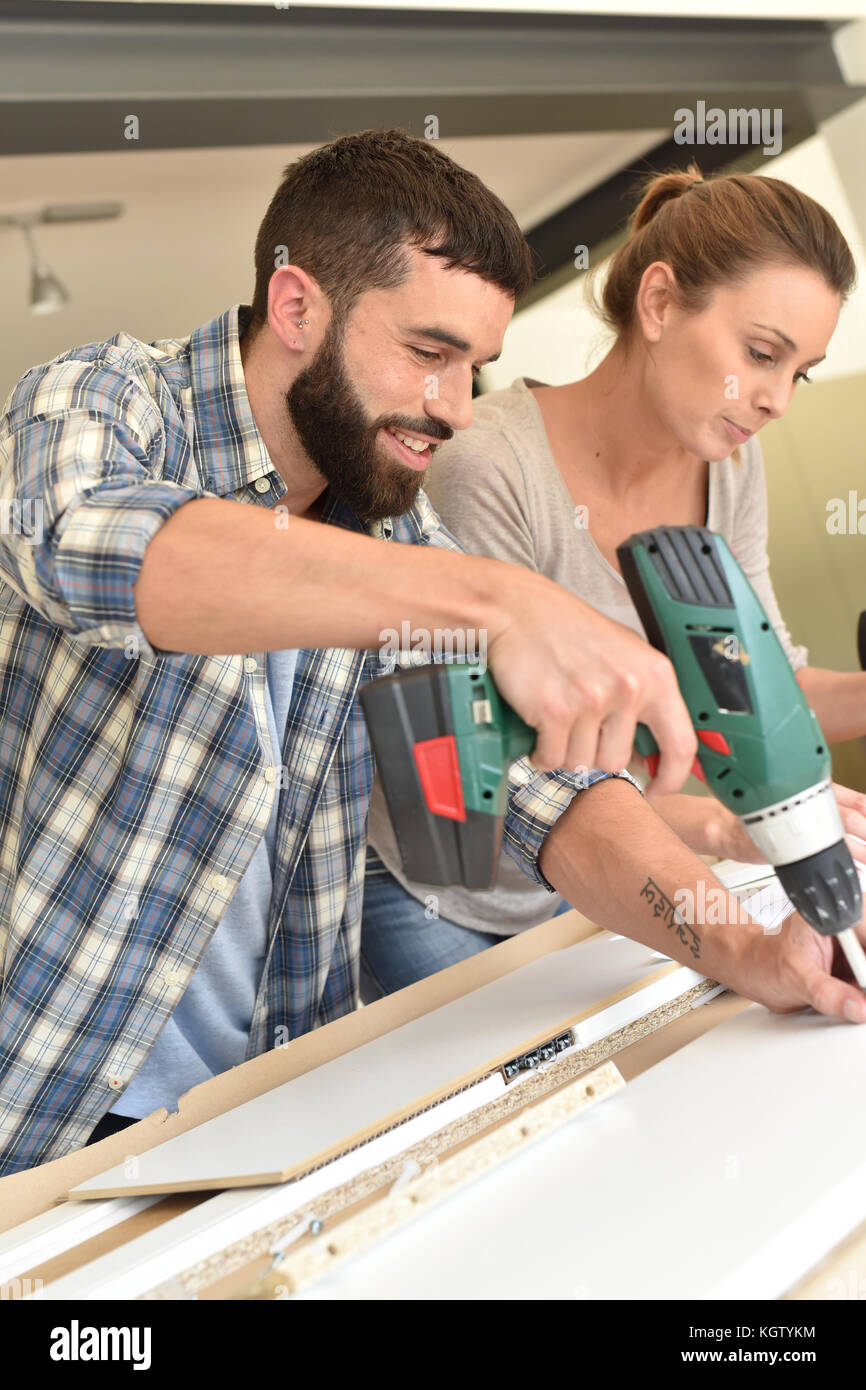Couple assembling new furniture Stock Photo - Alamy