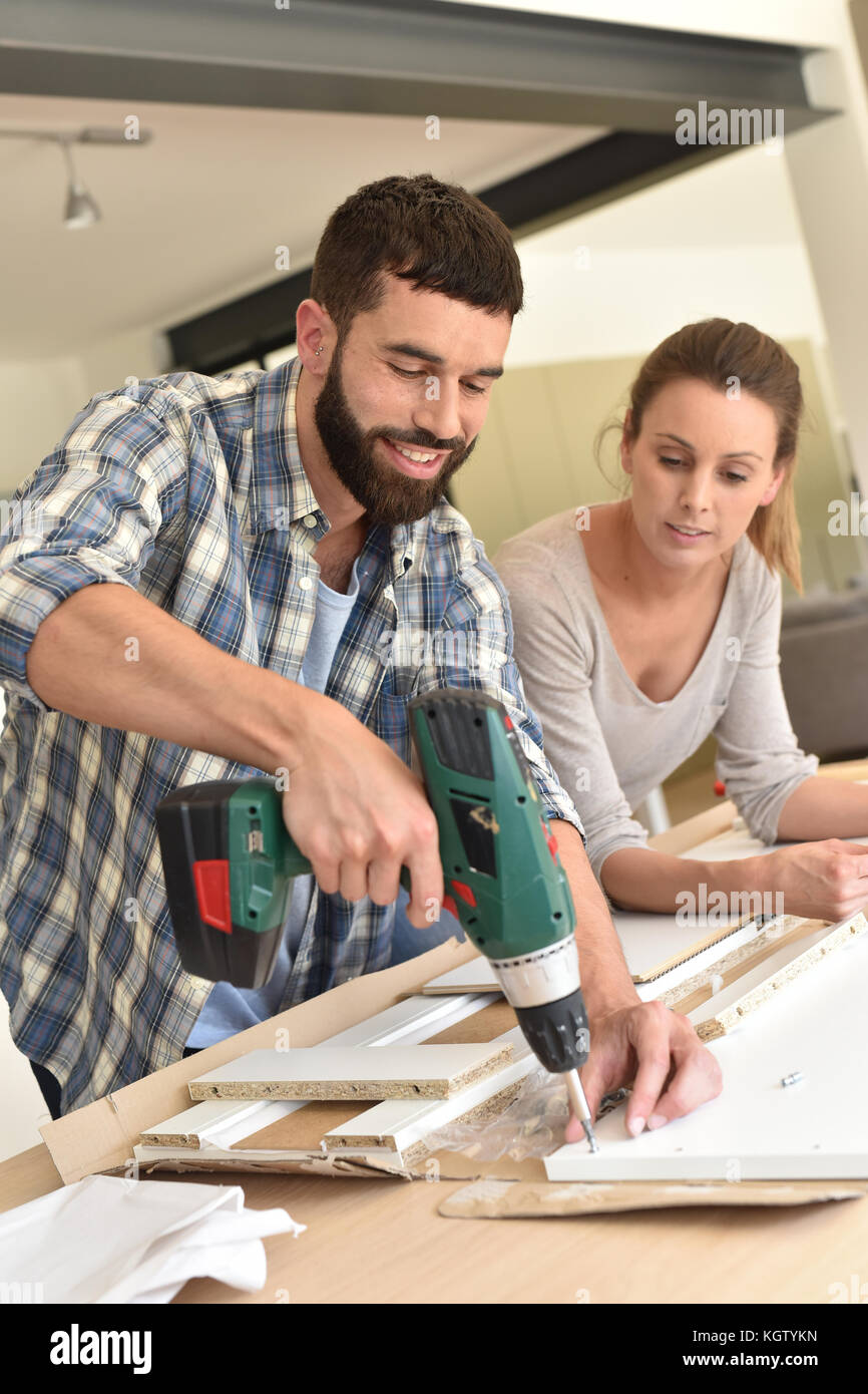 Couple assembling new furniture Stock Photo - Alamy