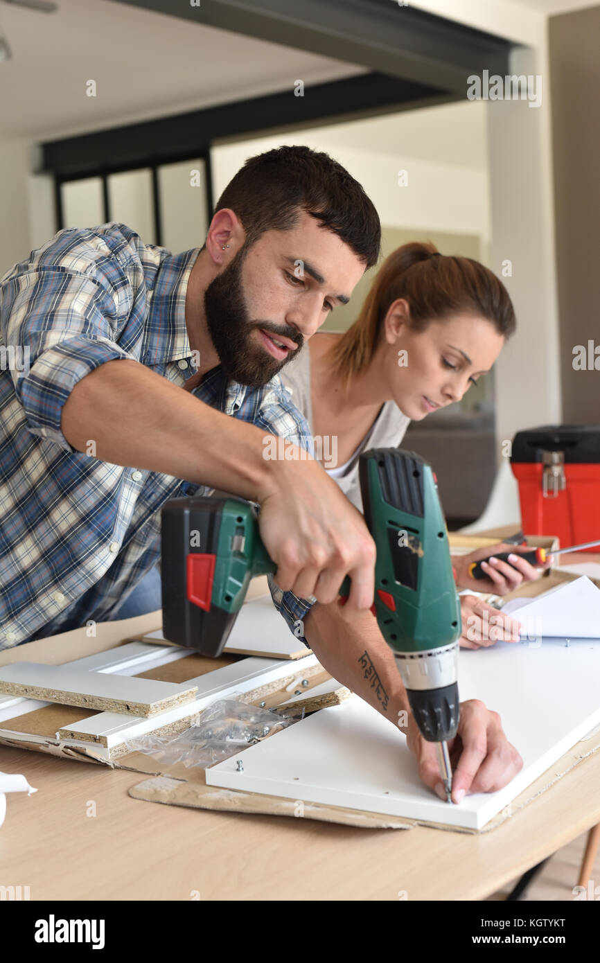 Couple assembling new furniture Stock Photo - Alamy