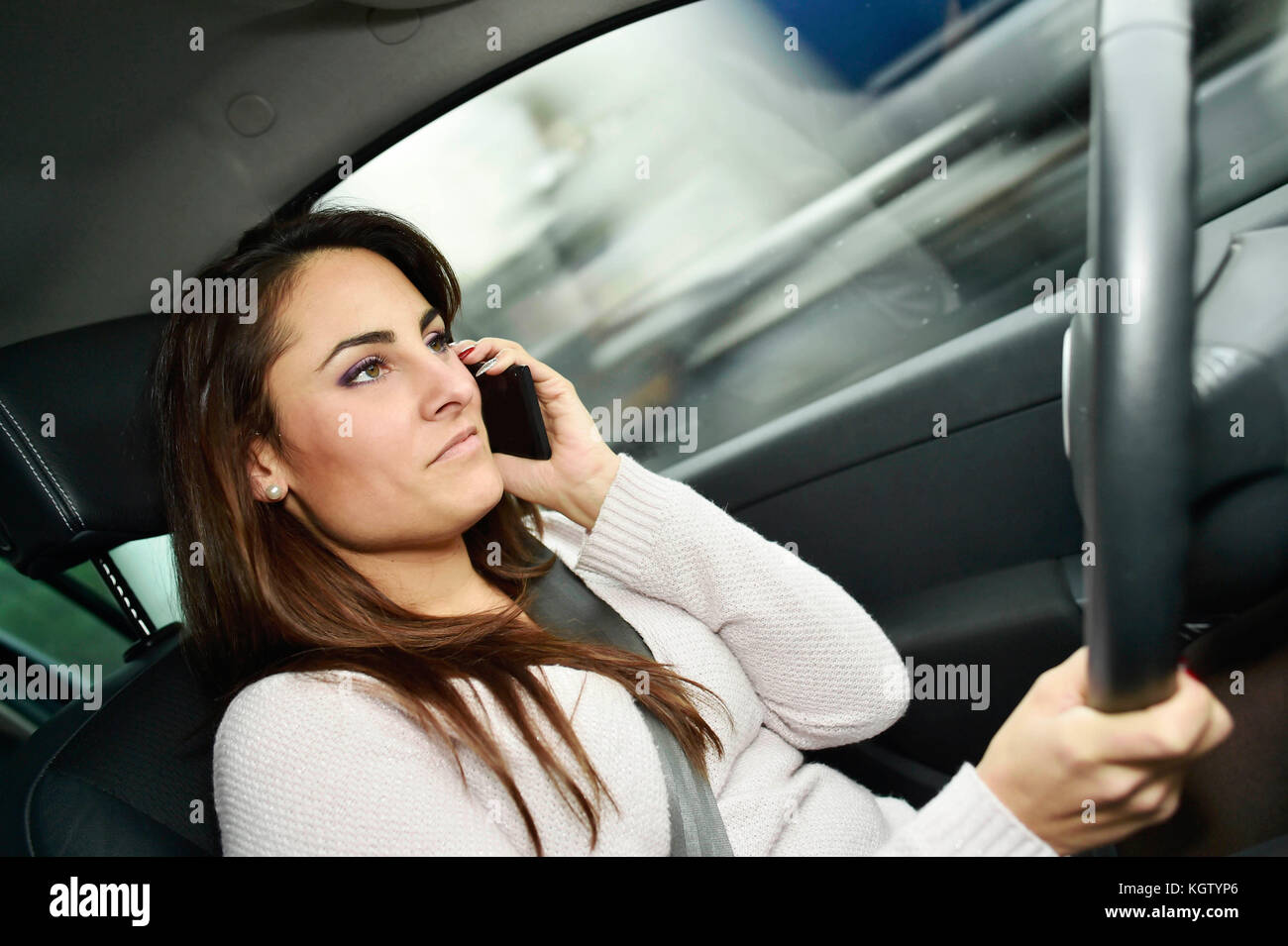 Woman talking on phone while driving Stock Photo - Alamy