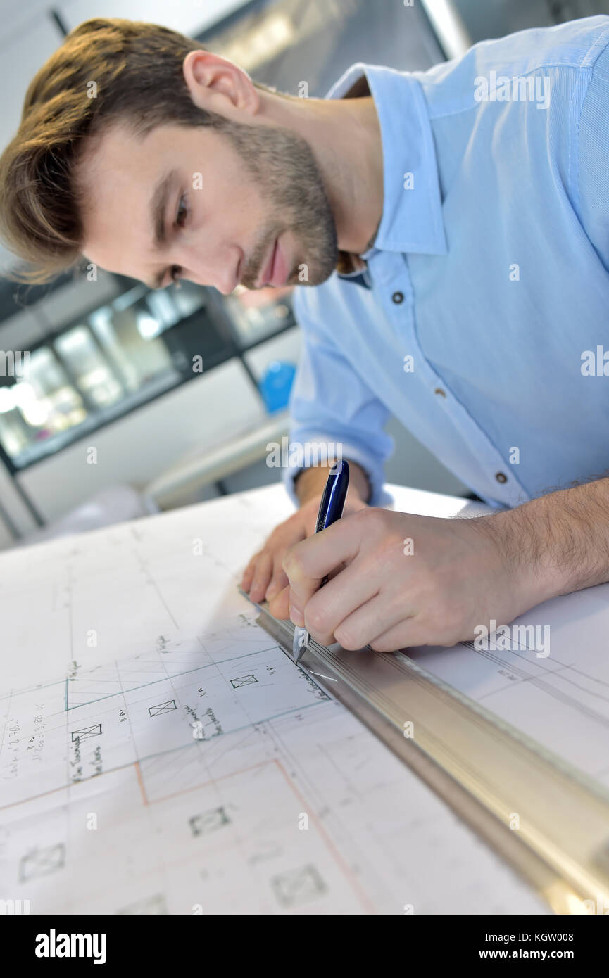 Architect designing on drafting table Stock Photo - Alamy