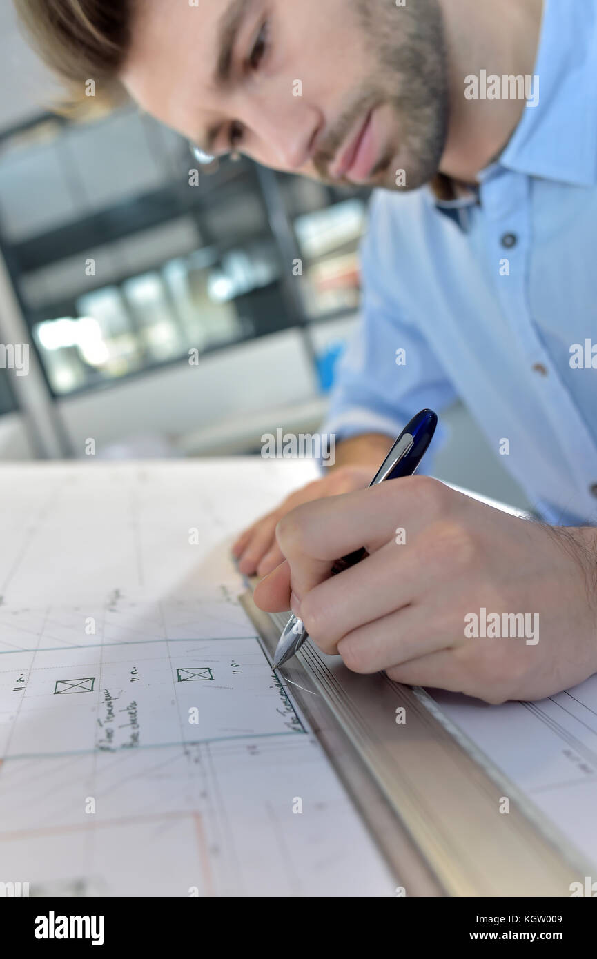 Architect designing on drafting table Stock Photo - Alamy