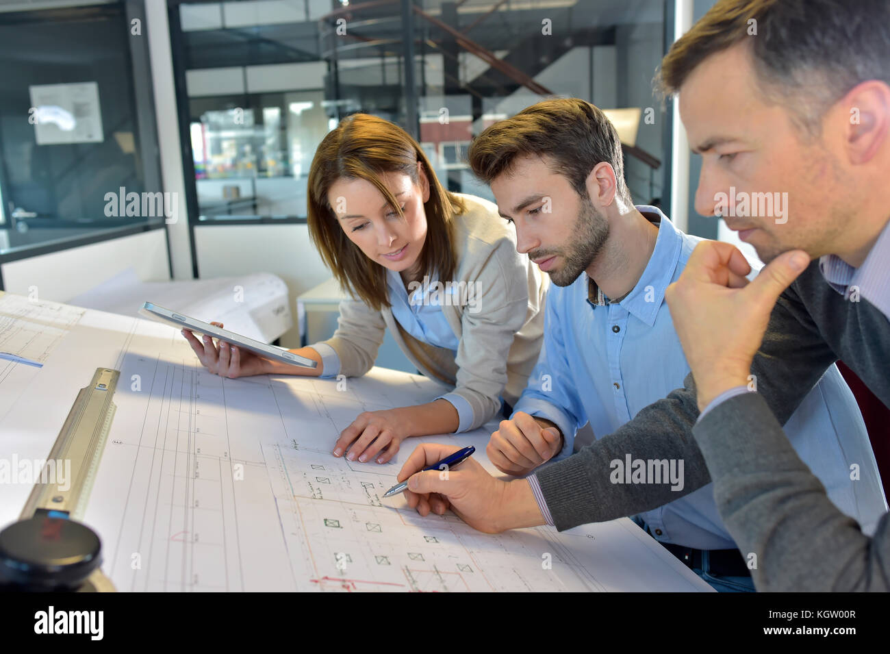 Team of architects working on construction project Stock Photo - Alamy