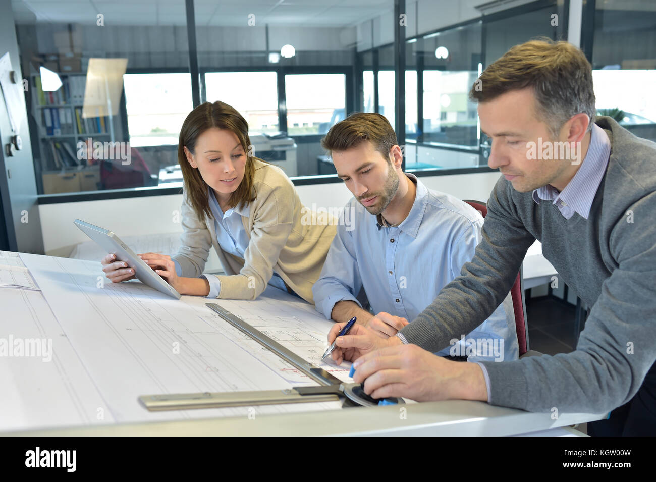 Team of architects working on construction project Stock Photo - Alamy