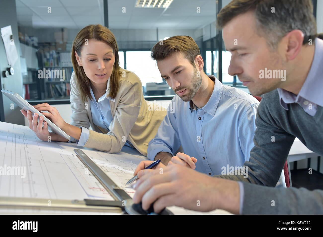 Team of architects working on construction project Stock Photo - Alamy
