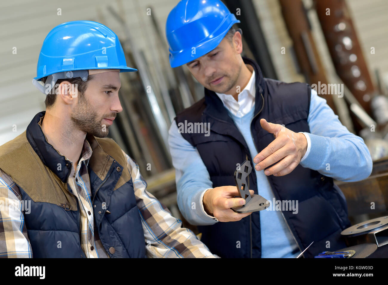 Engineer with mechanical worker checking on production Stock Photo - Alamy