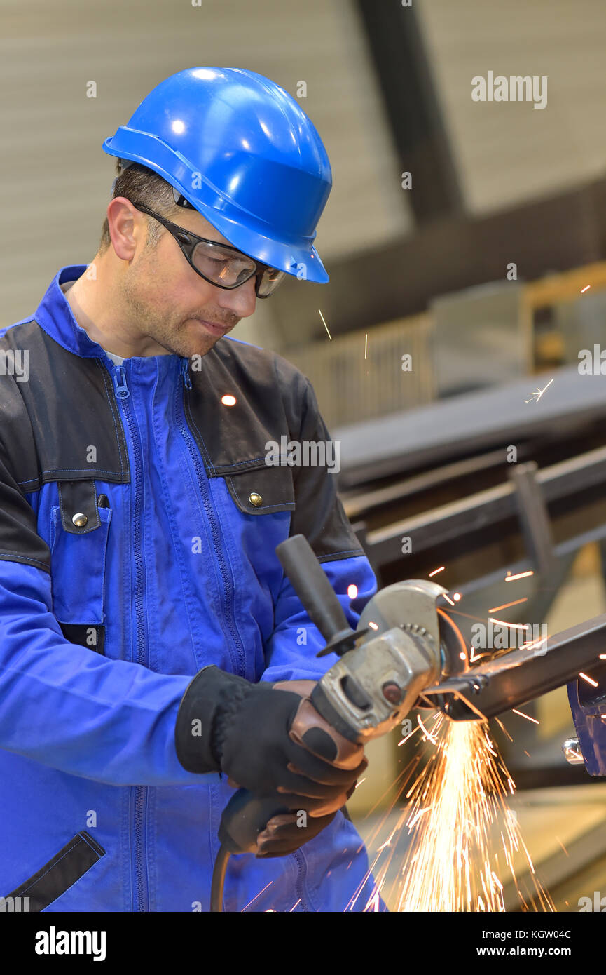 Man in factory working on metal Stock Photo - Alamy
