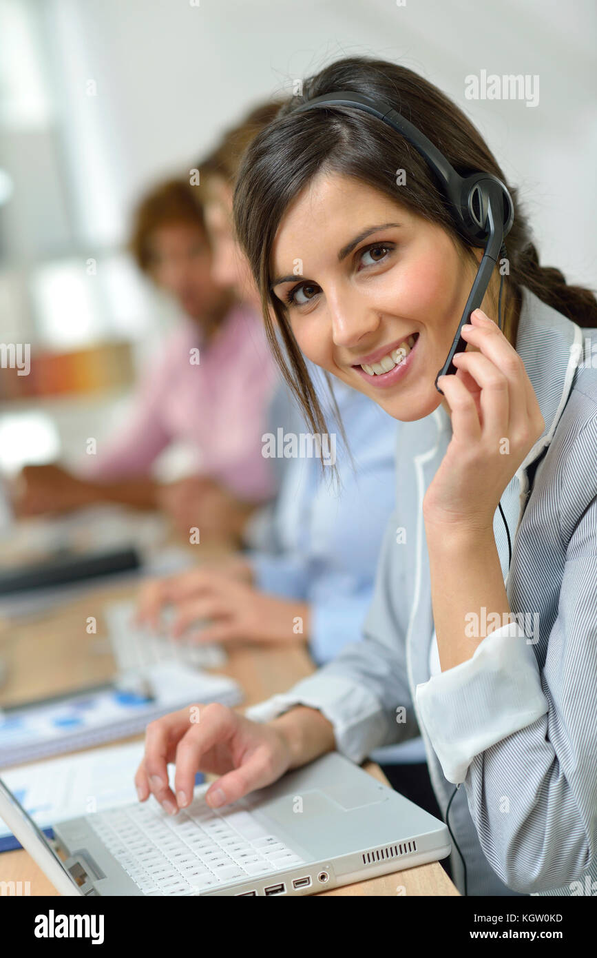 Beautiful smiling customer service representative Stock Photo - Alamy