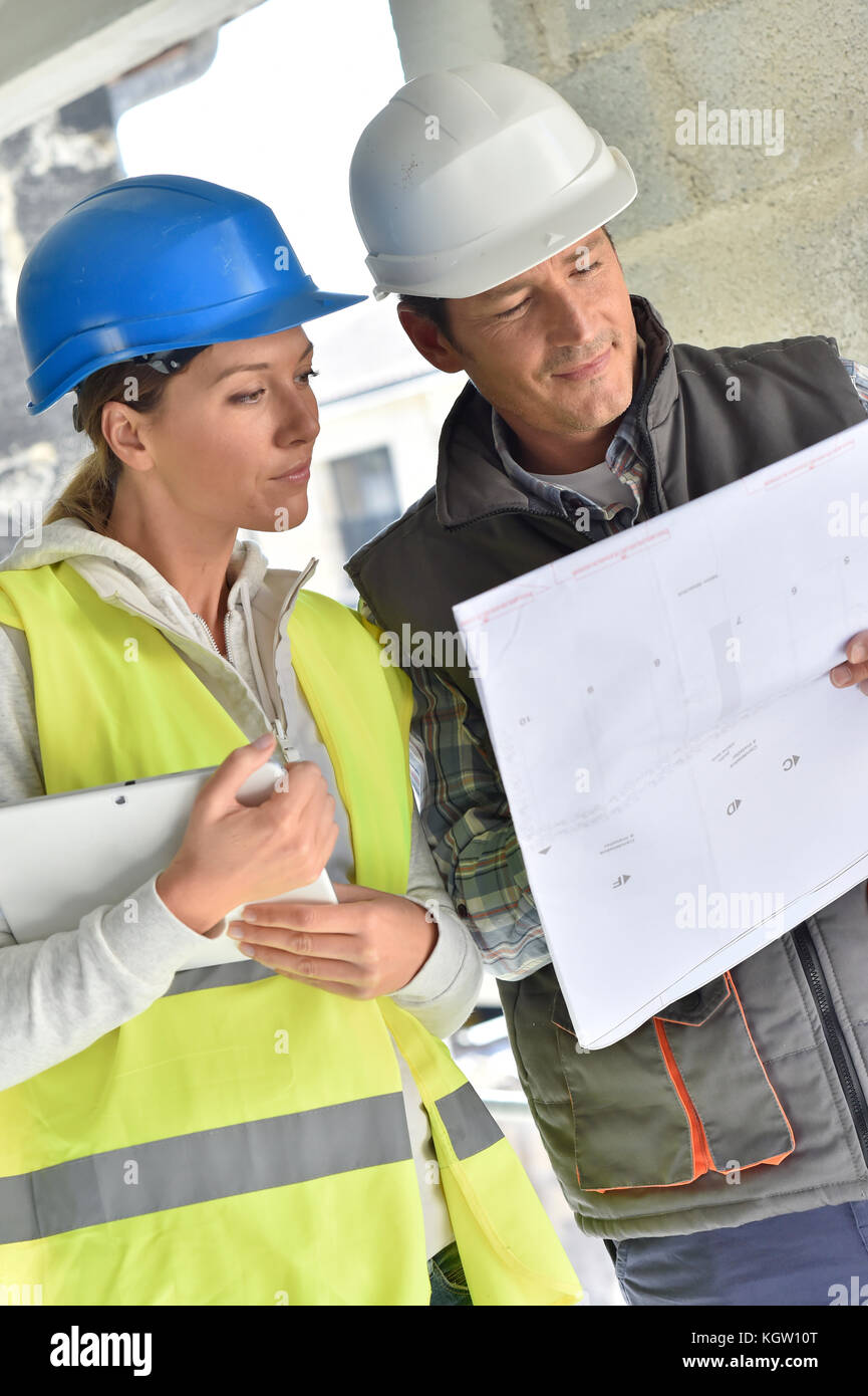 Construction team working on building site Stock Photo - Alamy