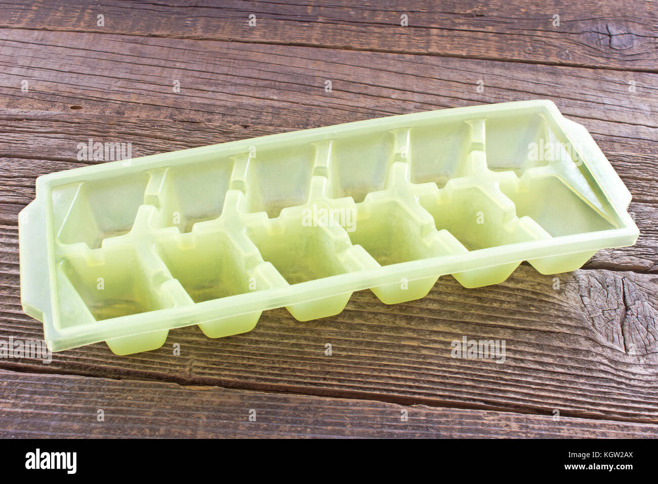 Plastic ice container on wooden background Stock Photo - Alamy