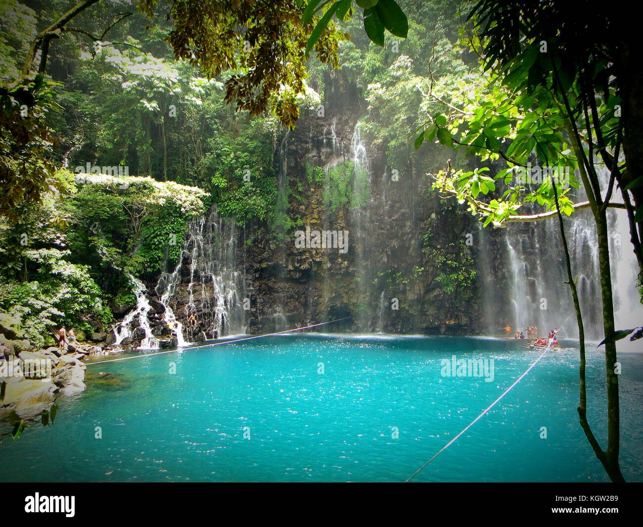Surreal view of the blue clear water of Tinago Falls framed by ...