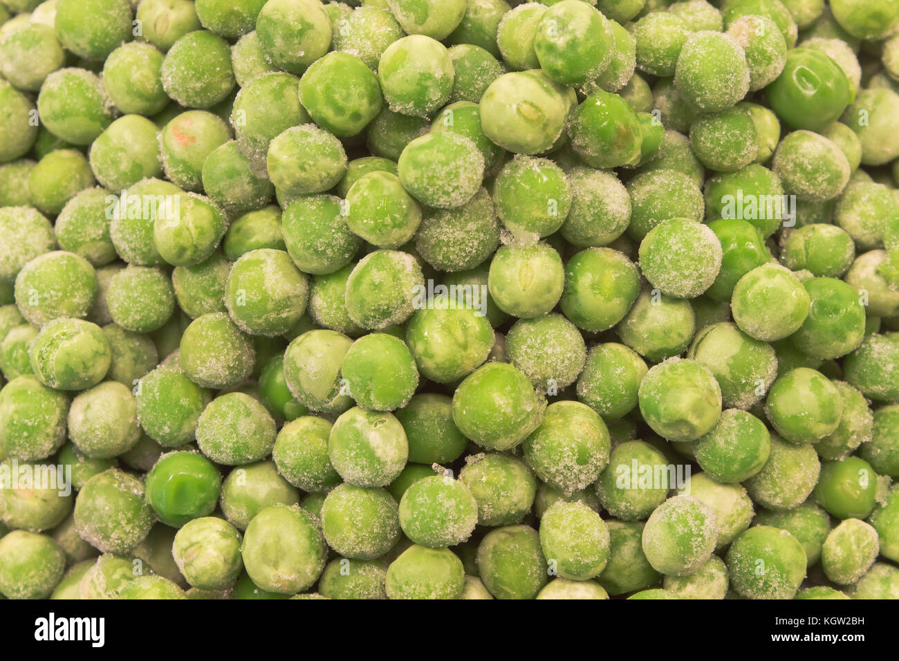Frozen peas heap as background Stock Photo - Alamy