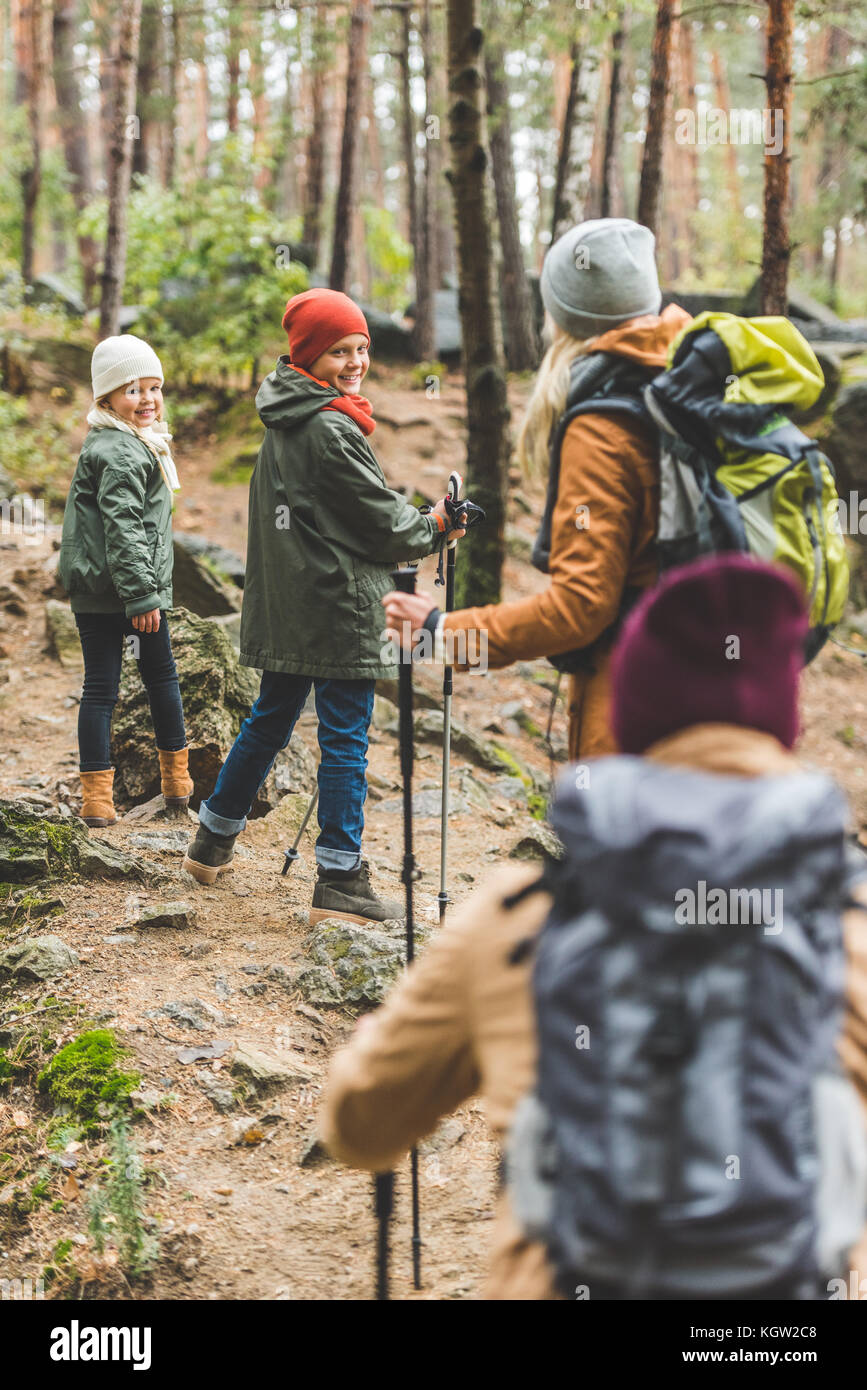 parents and kids trekking in forest Stock Photo - Alamy