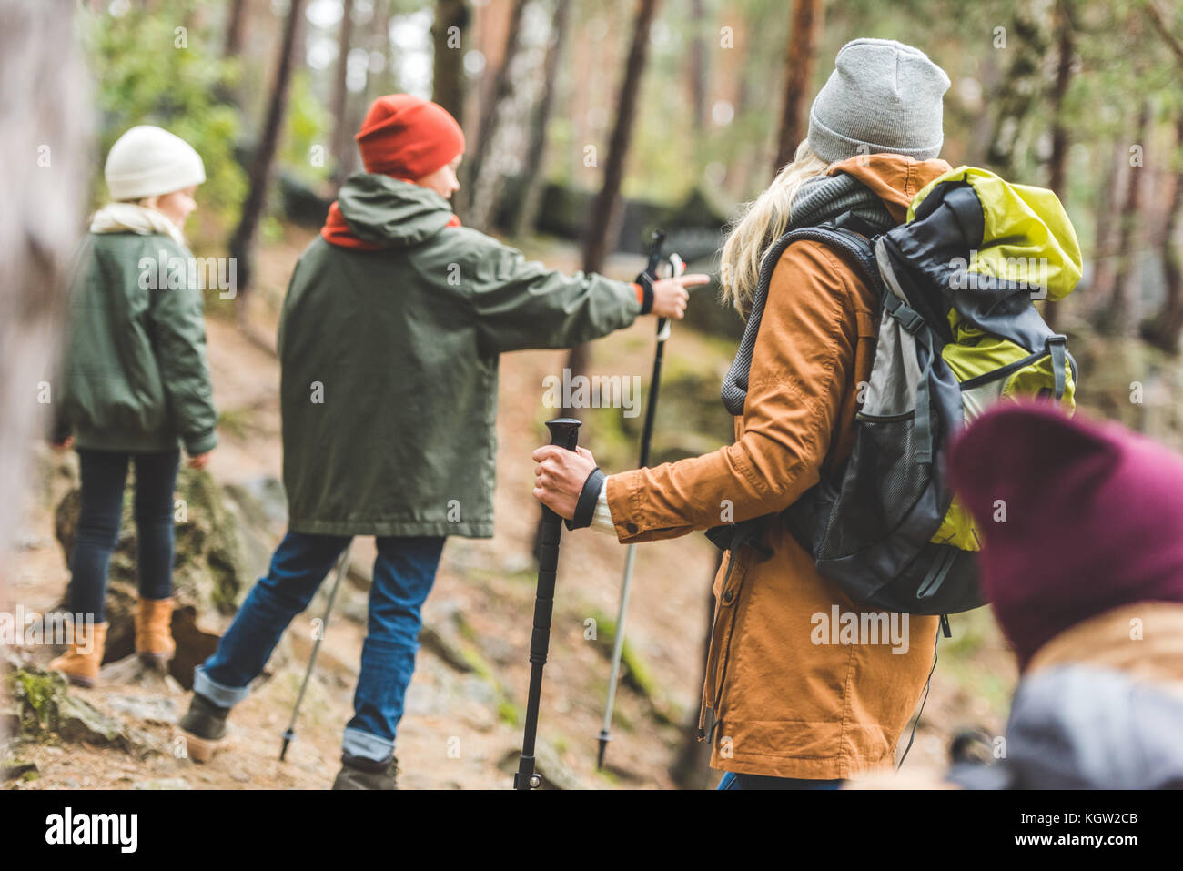 parents and kids trekking in forest Stock Photo - Alamy