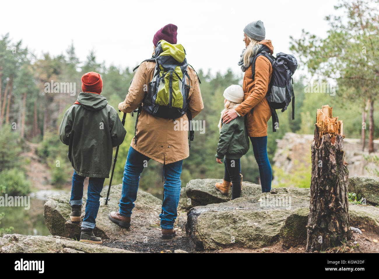parents and kids trekking in forest Stock Photo - Alamy