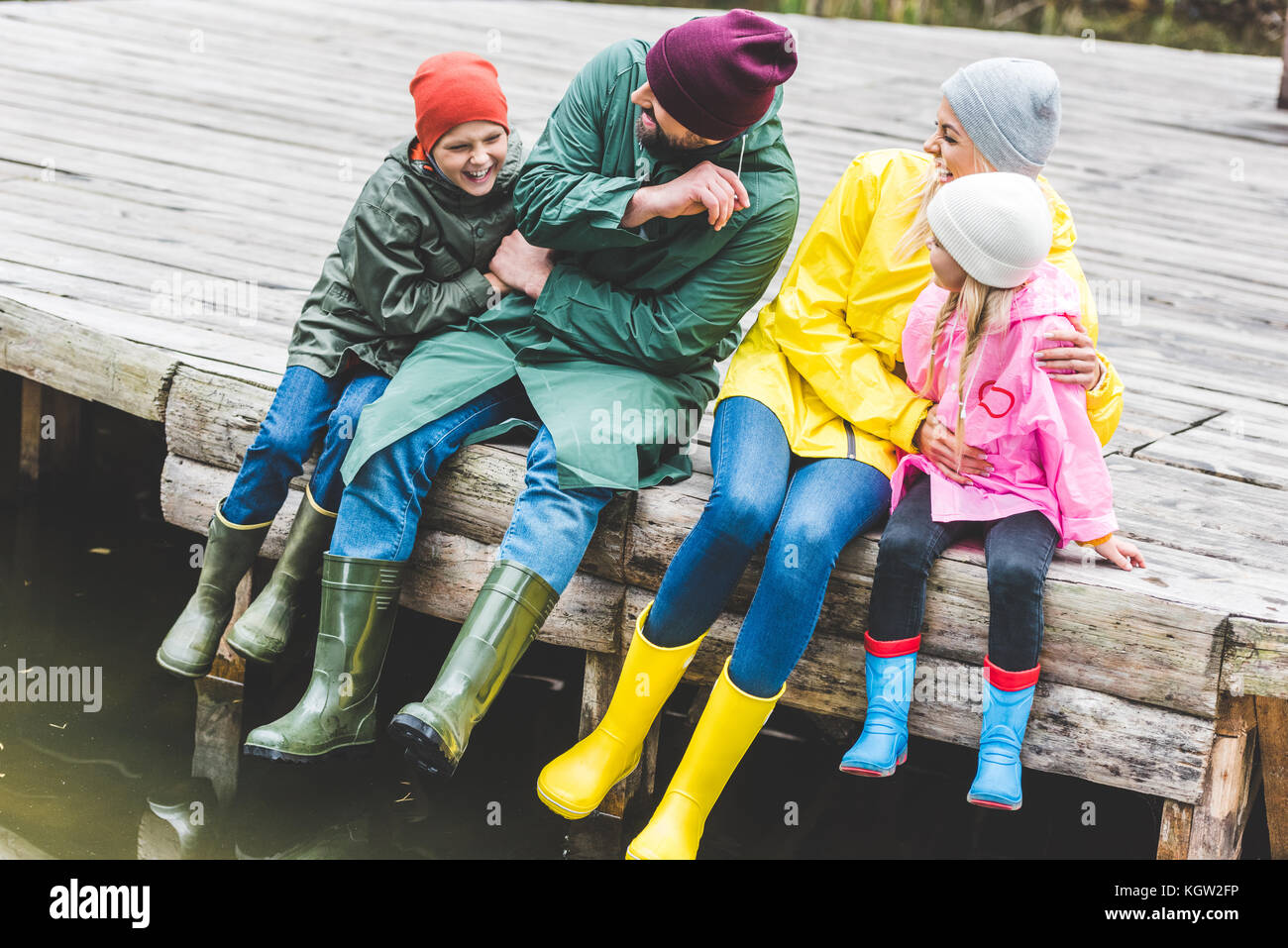 family resting at river Stock Photo - Alamy