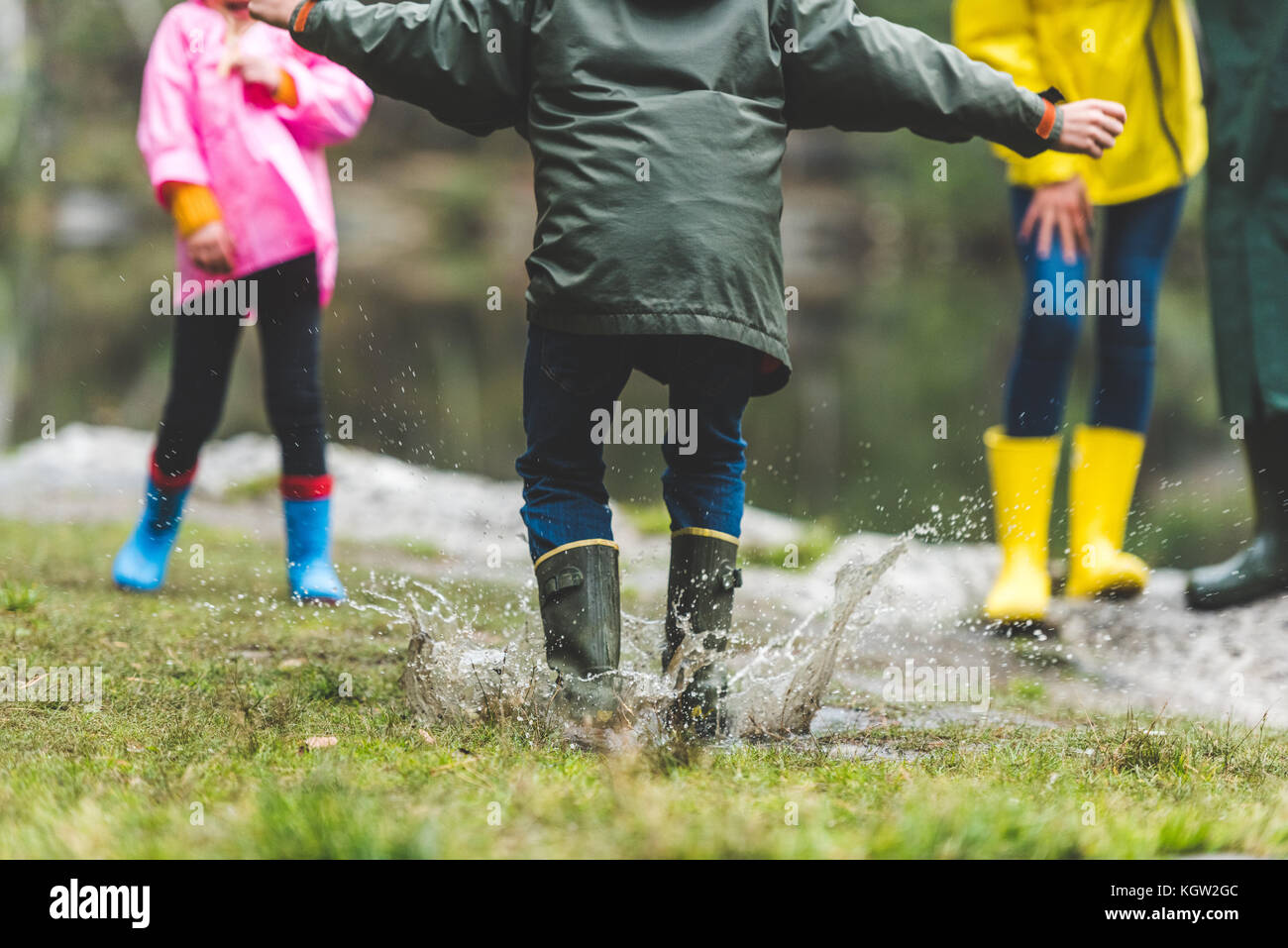 kid jumping in muddy puddle Stock Photo - Alamy